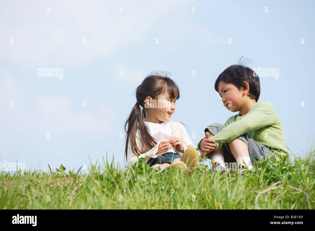 Smiling children talking in park Stock Photo - Alamy