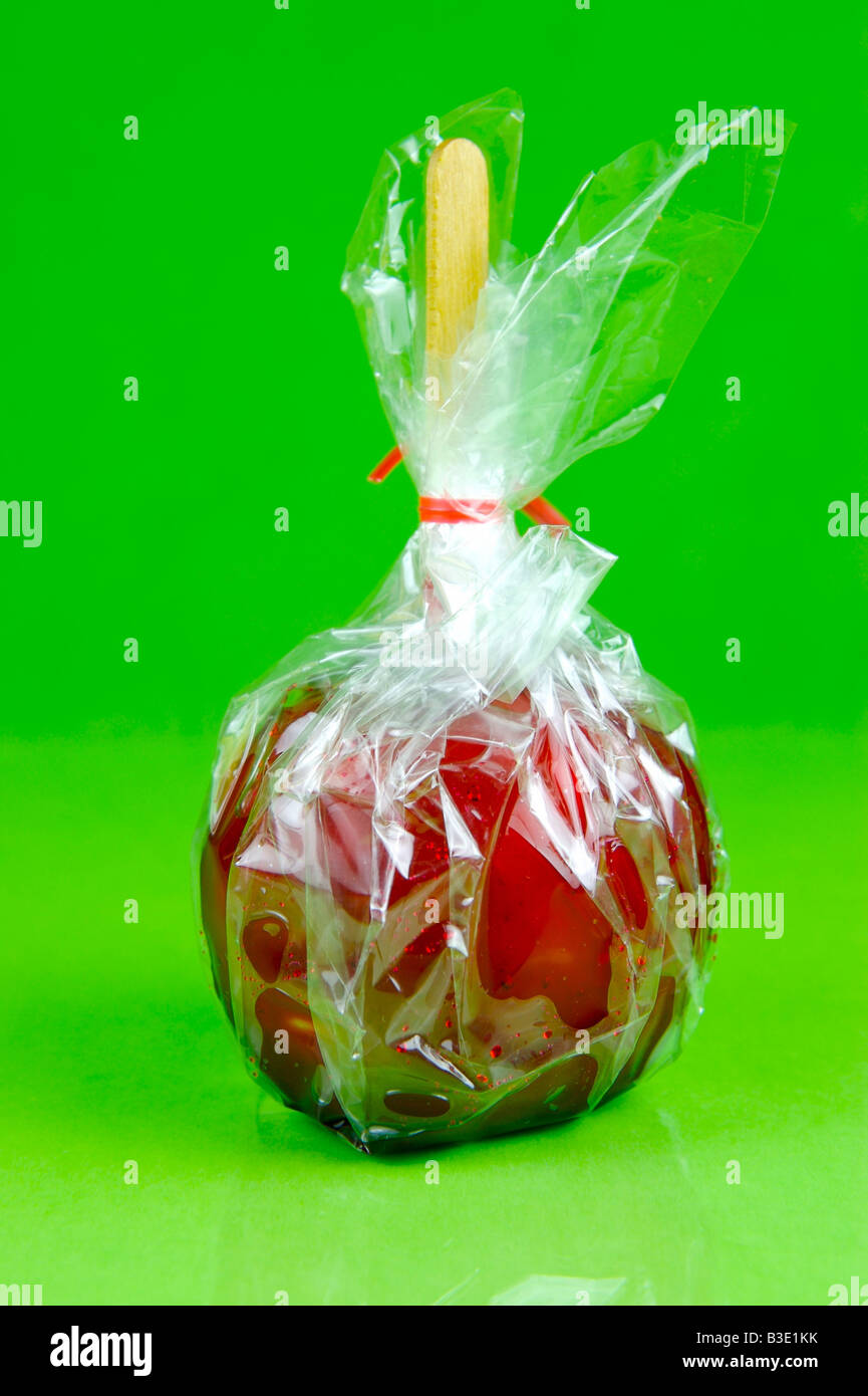 Candy apples isolated against a green background Stock Photo - Alamy
