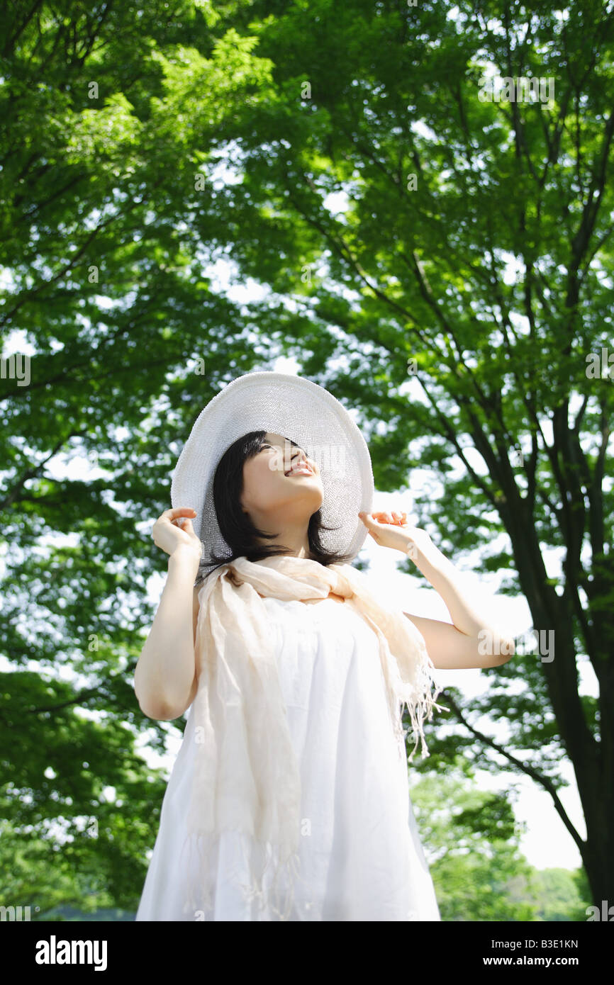 A young woman looking at green trees Stock Photo - Alamy