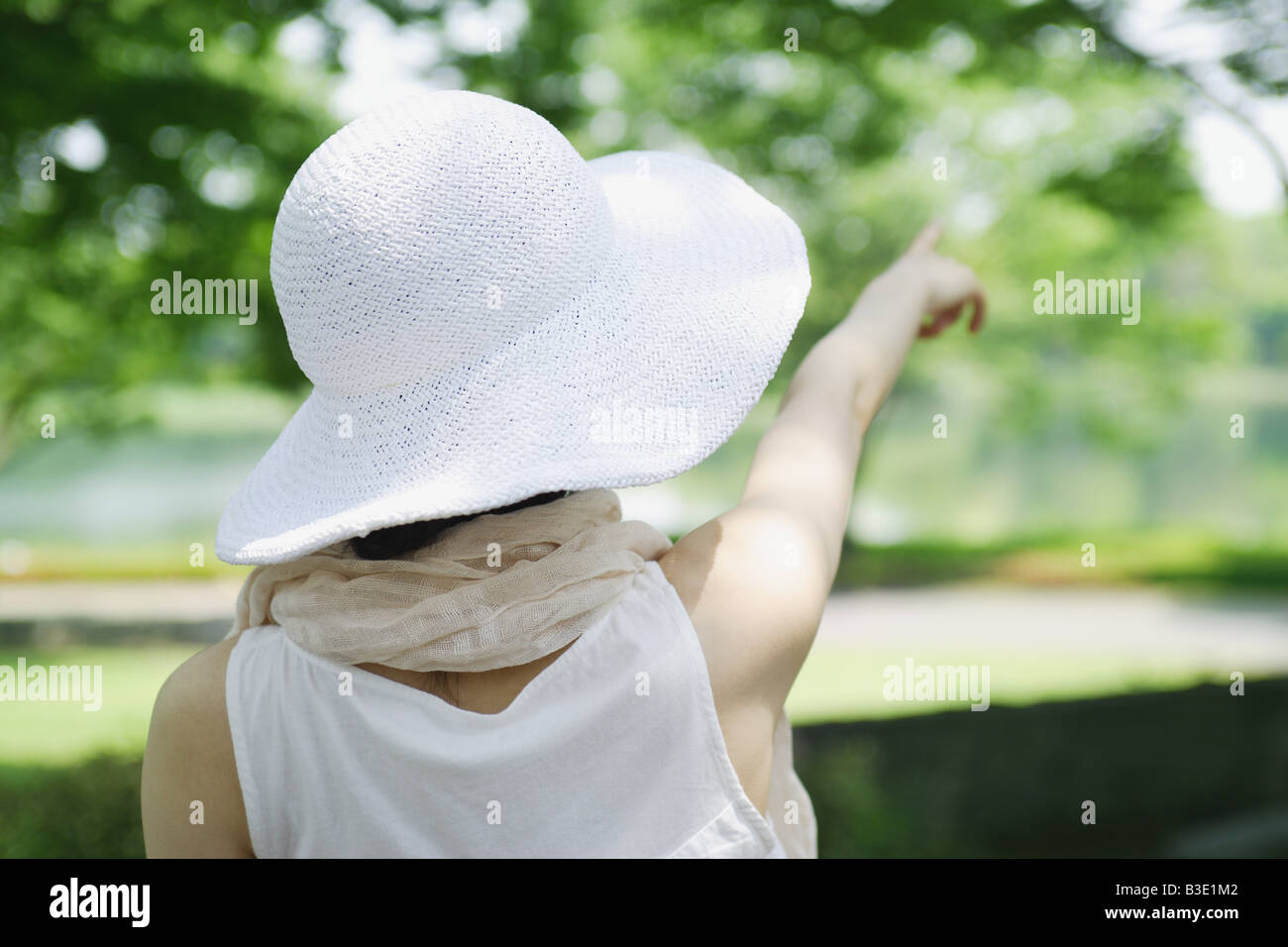 A woman wearing hat and pointing Stock Photo - Alamy