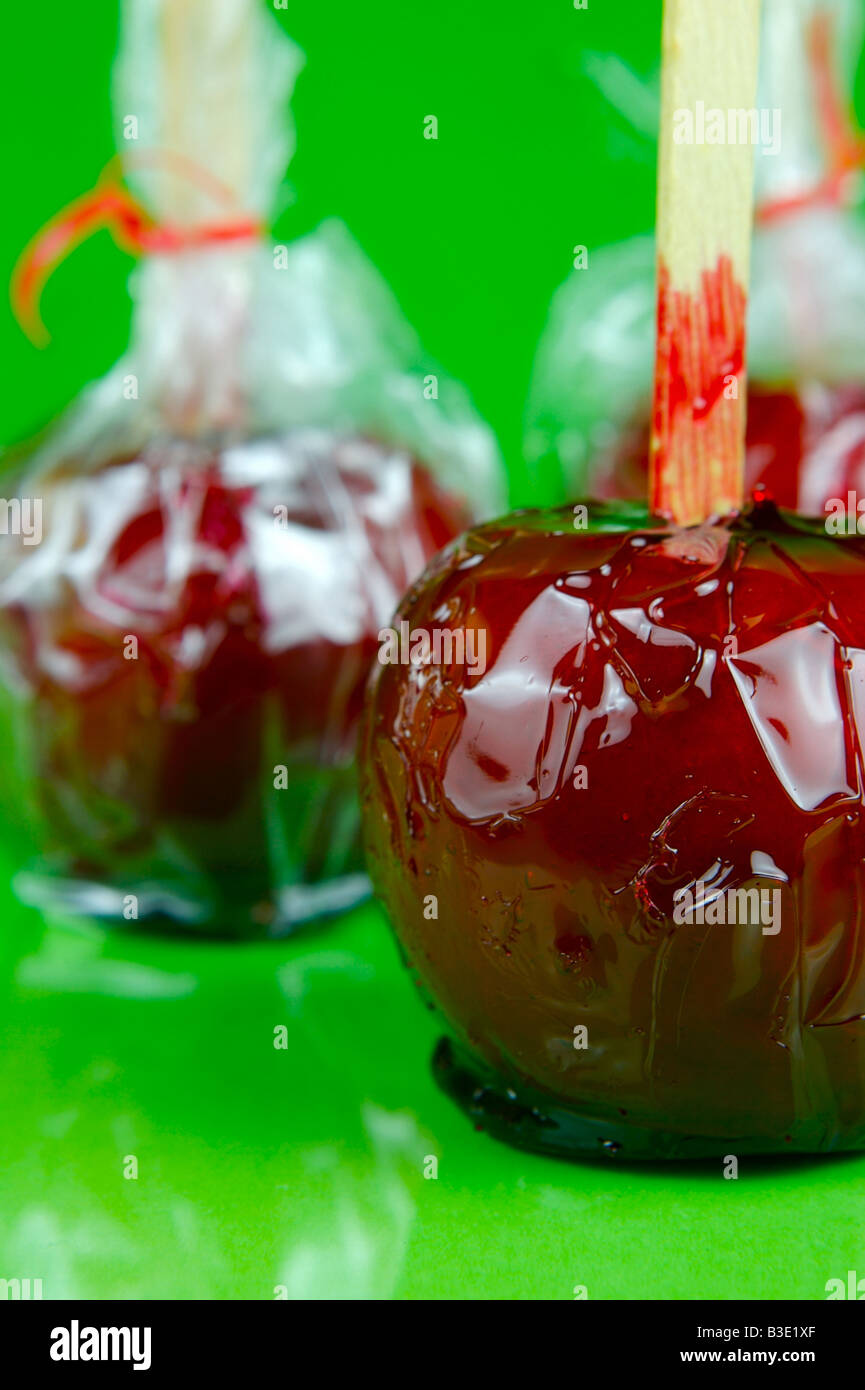Candy apples isolated against a green background Stock Photo - Alamy