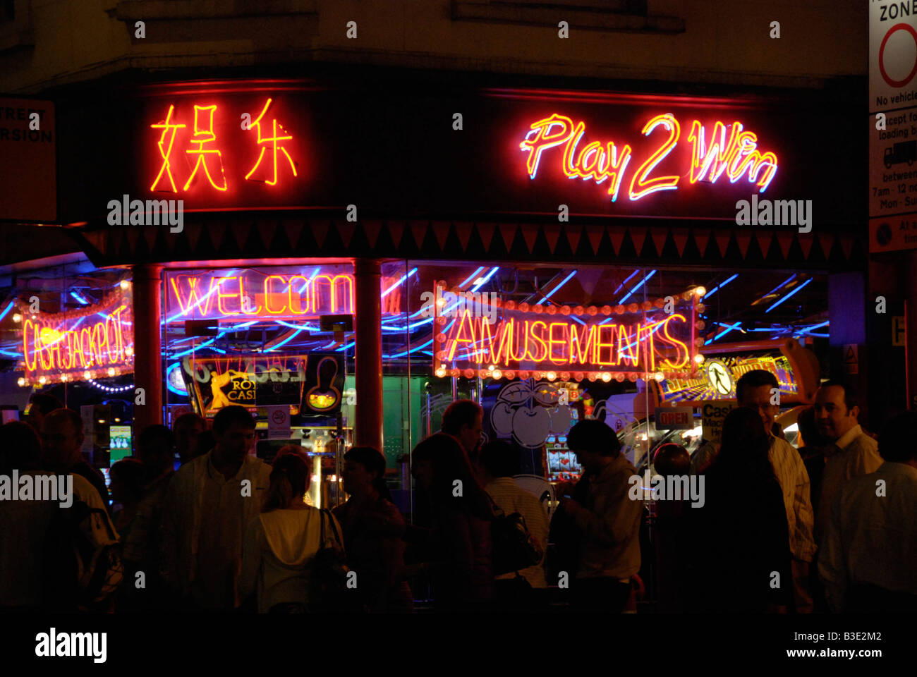 People outside amusement arcade at night Chinatown London England Stock ...