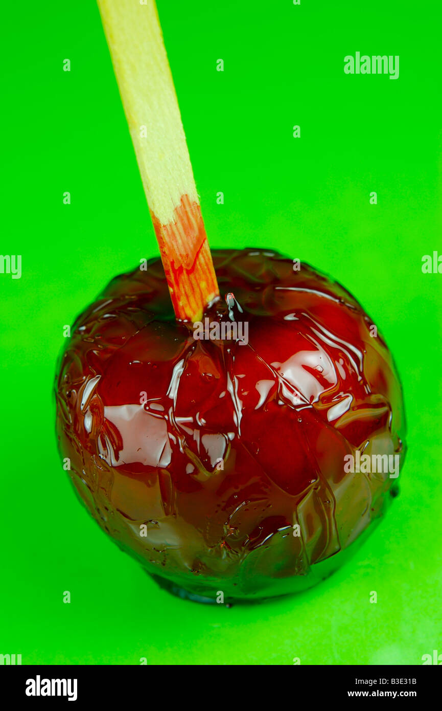 Candy apples isolated against a green background Stock Photo - Alamy