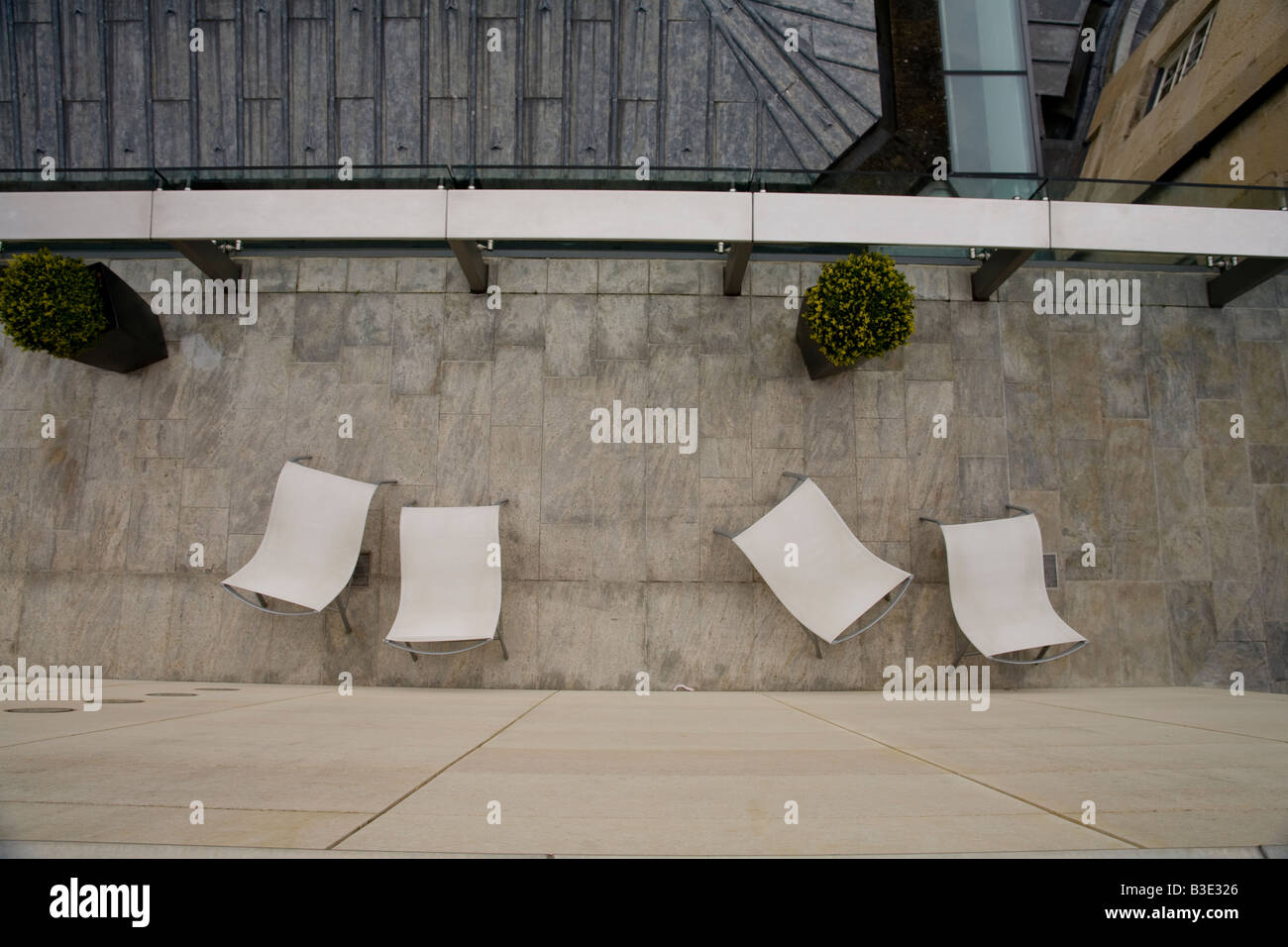 Looking down on sun loungers on a rooftop terrace Stock Photo - Alamy
