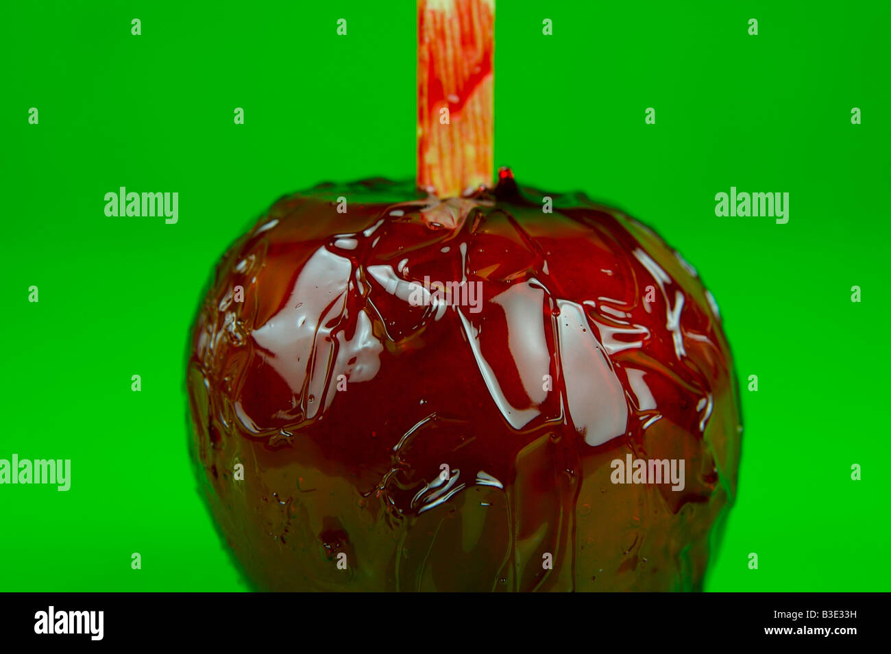 Candy apples isolated against a green background Stock Photo - Alamy