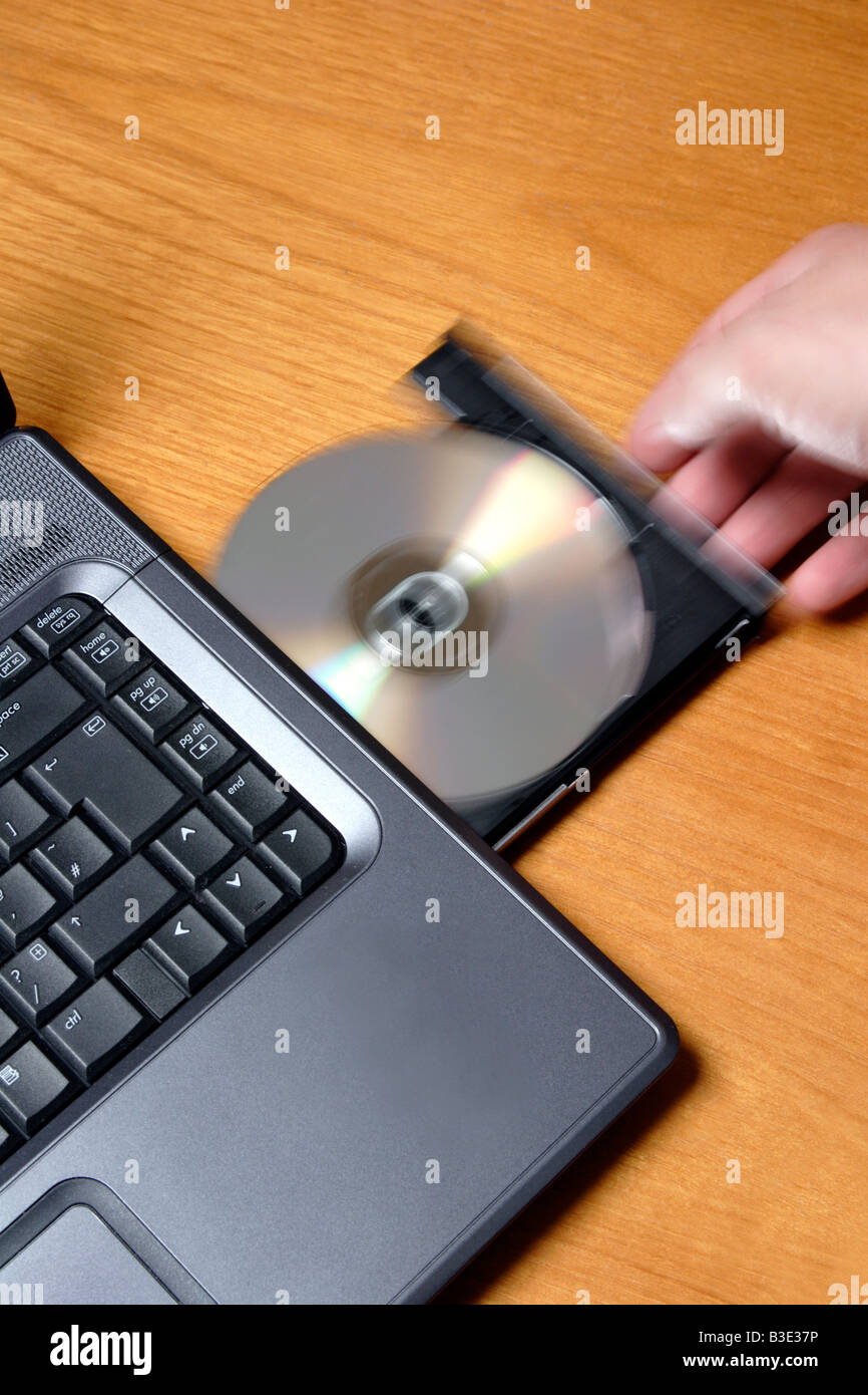 person closing disk drive on laptop computer Stock Photo - Alamy