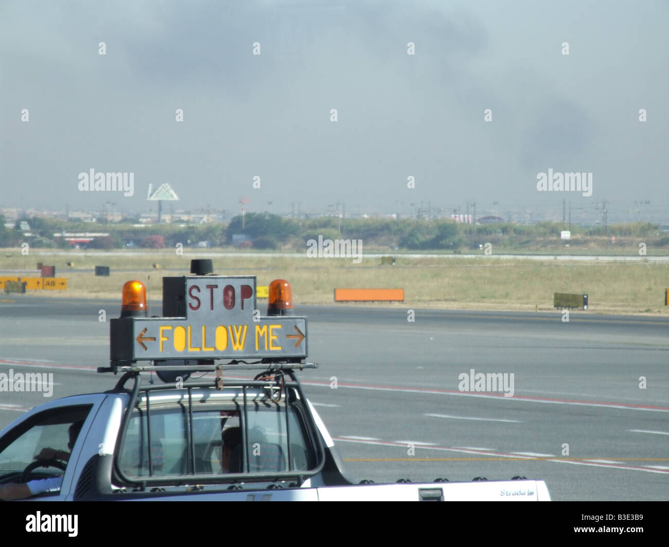 vehicle with stop follow me sign on airport tarmac Stock Photo - Alamy