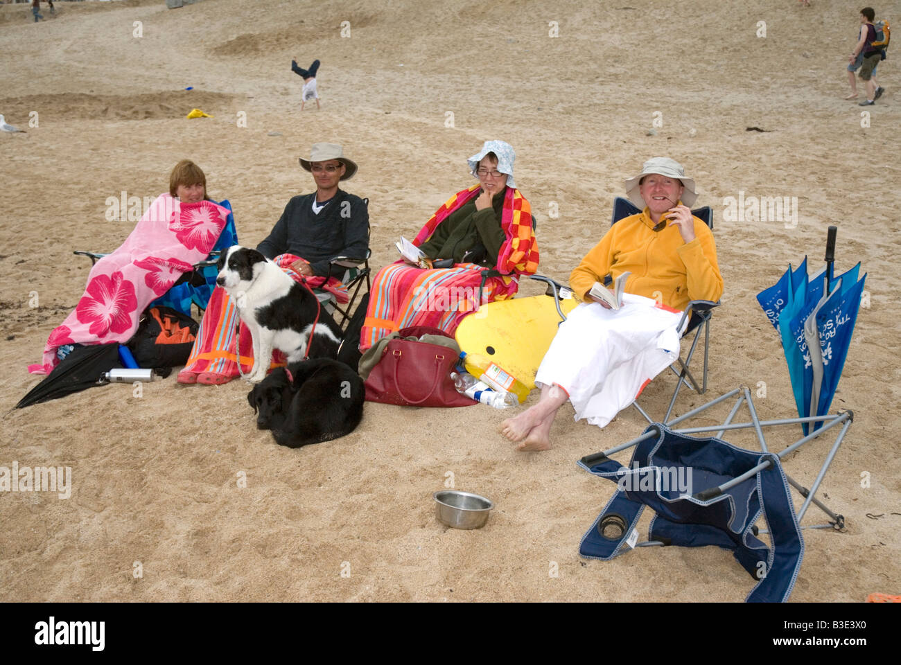 English behaviour English people sitting on the beach in the rain ...