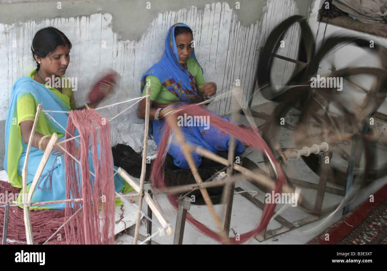 Two women spinning threads in India Stock Photo - Alamy