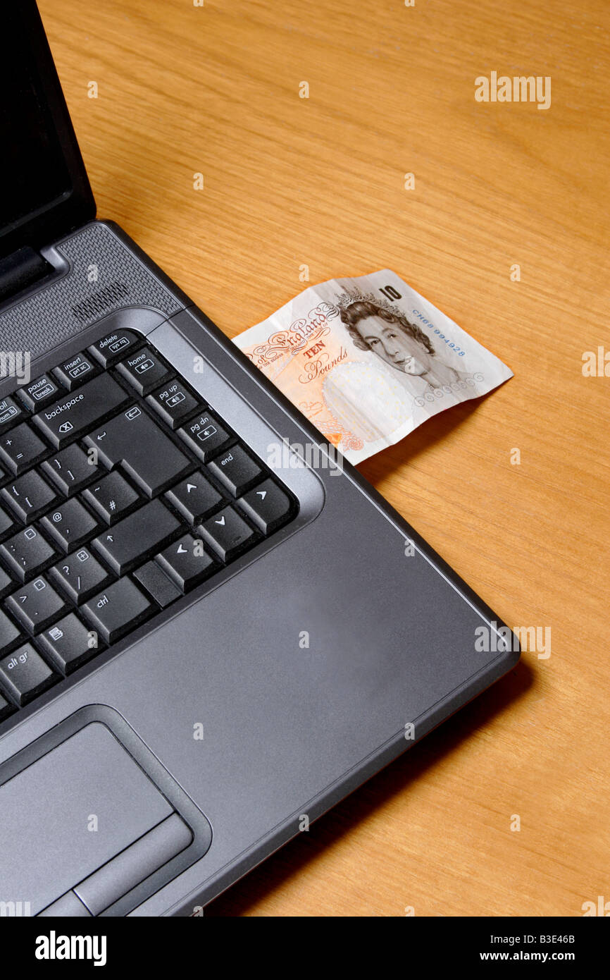 Making cash from laptop computer close up Stock Photo - Alamy
