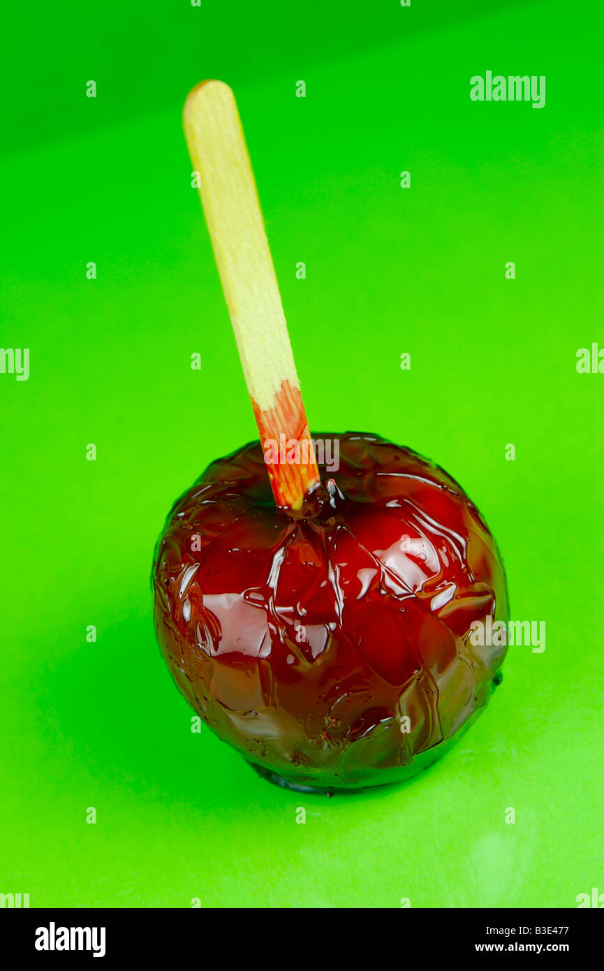 Candy apples isolated against a green background Stock Photo - Alamy