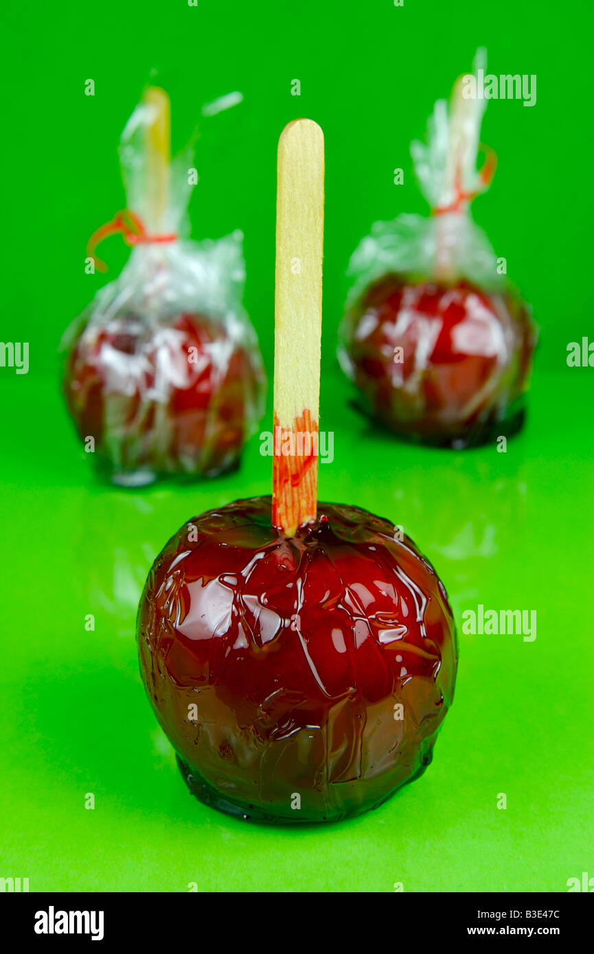 Candy apples isolated against a green background Stock Photo - Alamy