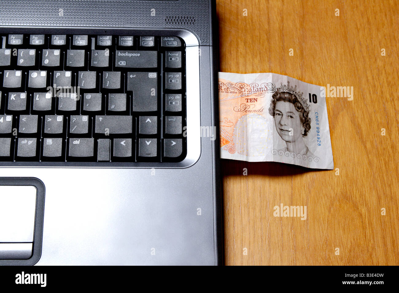 Making cash from laptop computer close up Stock Photo - Alamy