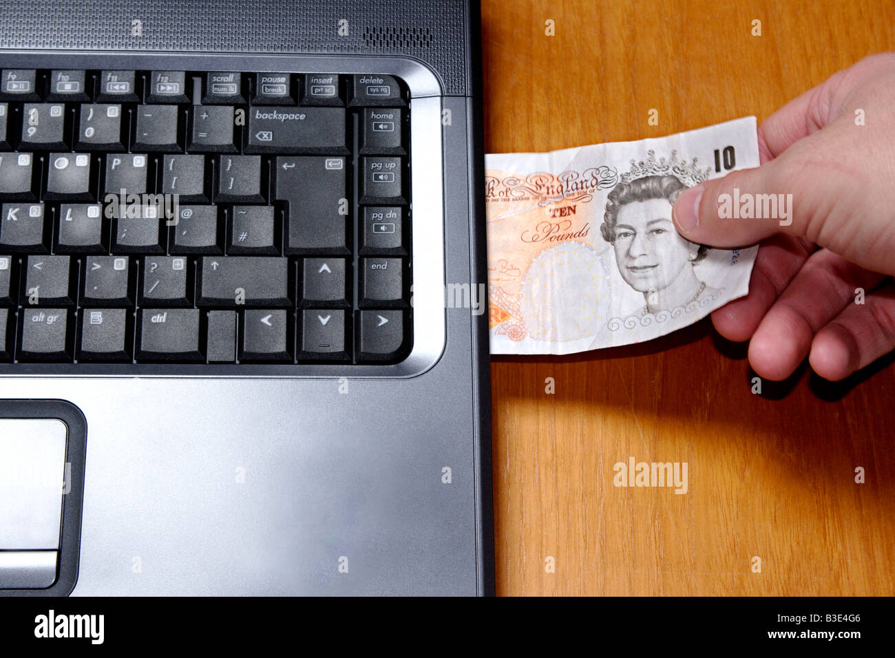 Person taking cash from laptop computer close up Stock Photo - Alamy