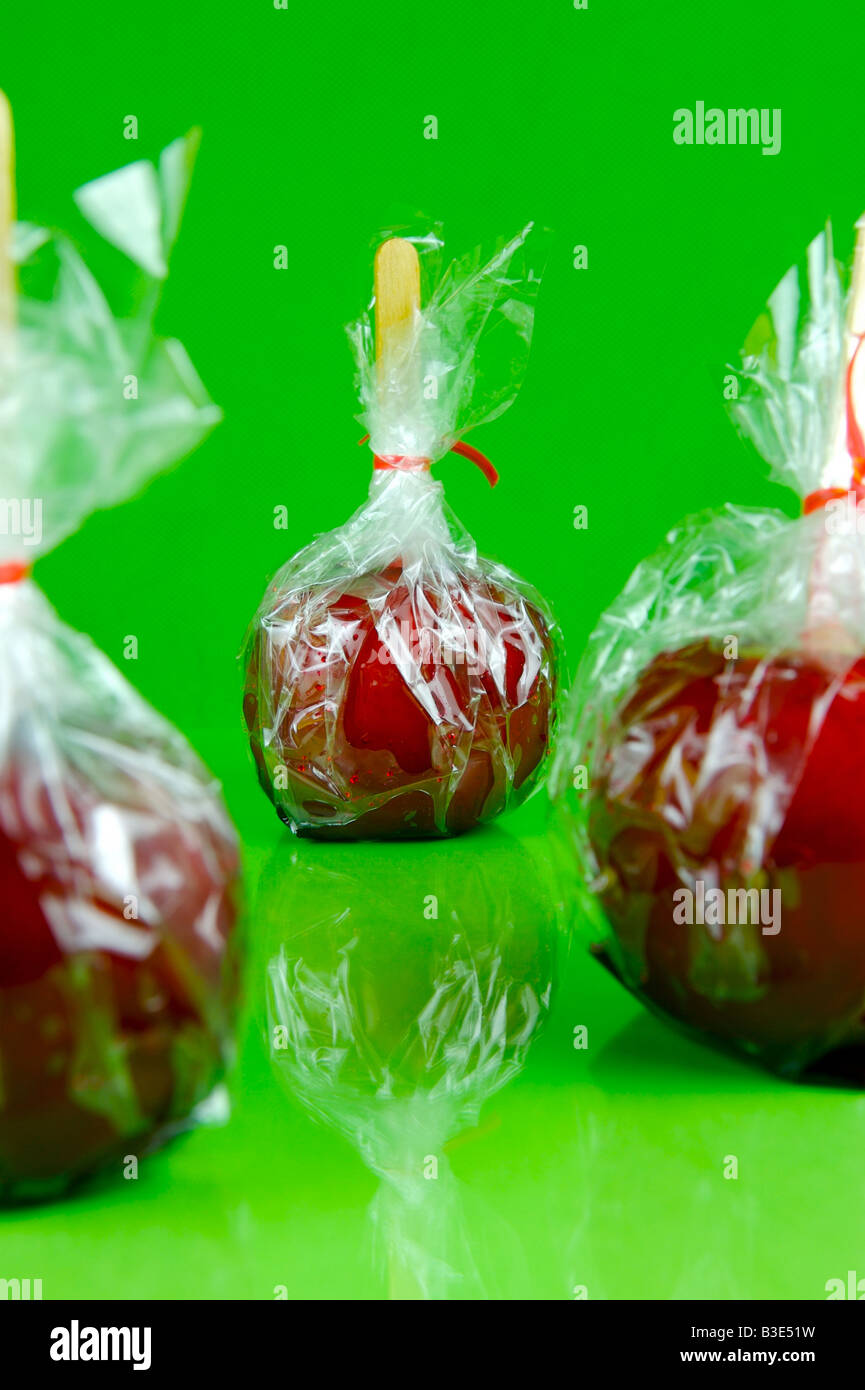 Candy apples isolated against a green background Stock Photo - Alamy