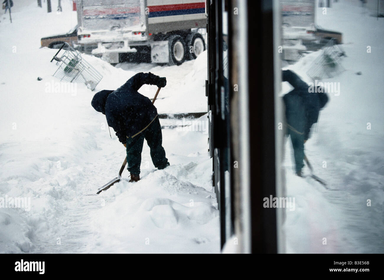miserable man shovels snow after winter storm blizzard Stock Photo - Alamy