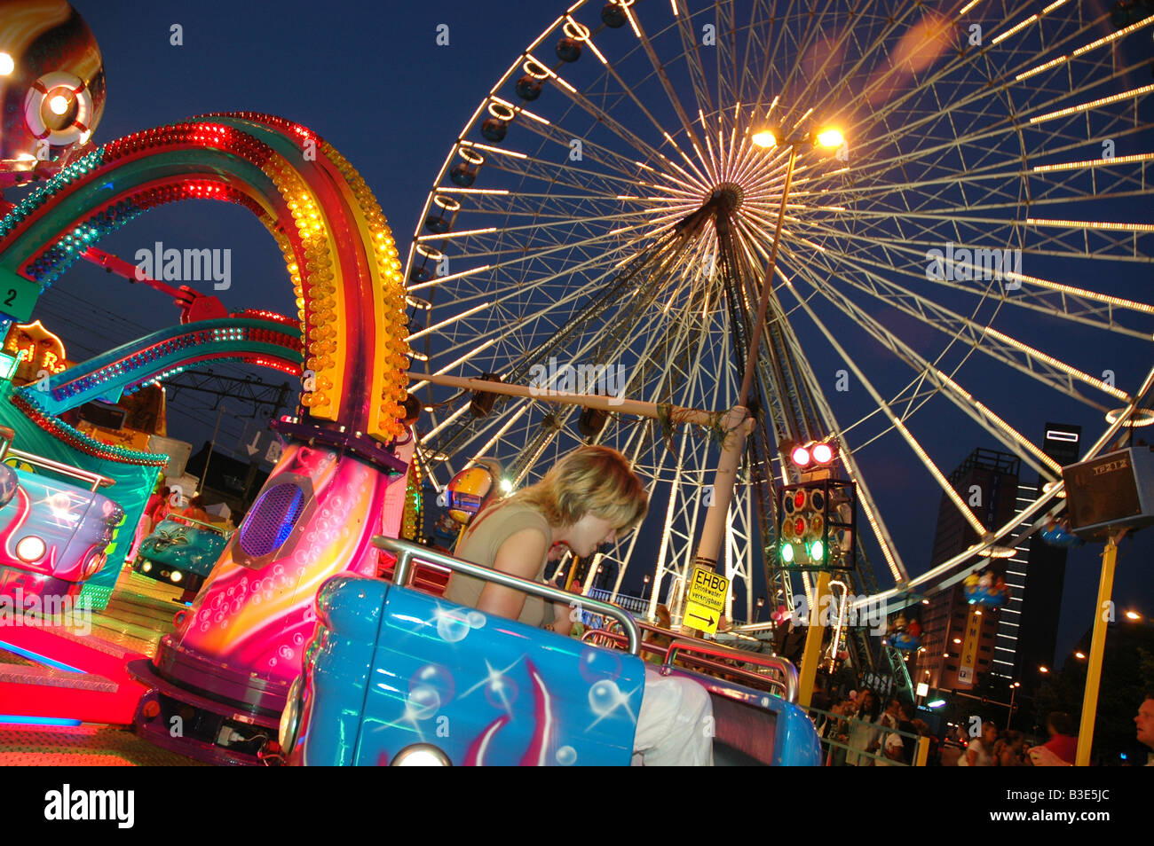 colourful fairground with ferris wheel at dusk Stock Photo - Alamy