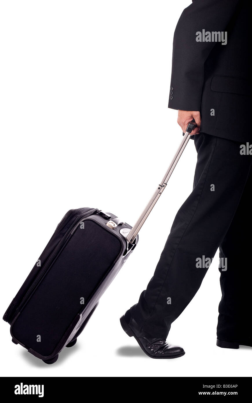 Business man walking with pull behind luggage Stock Photo - Alamy