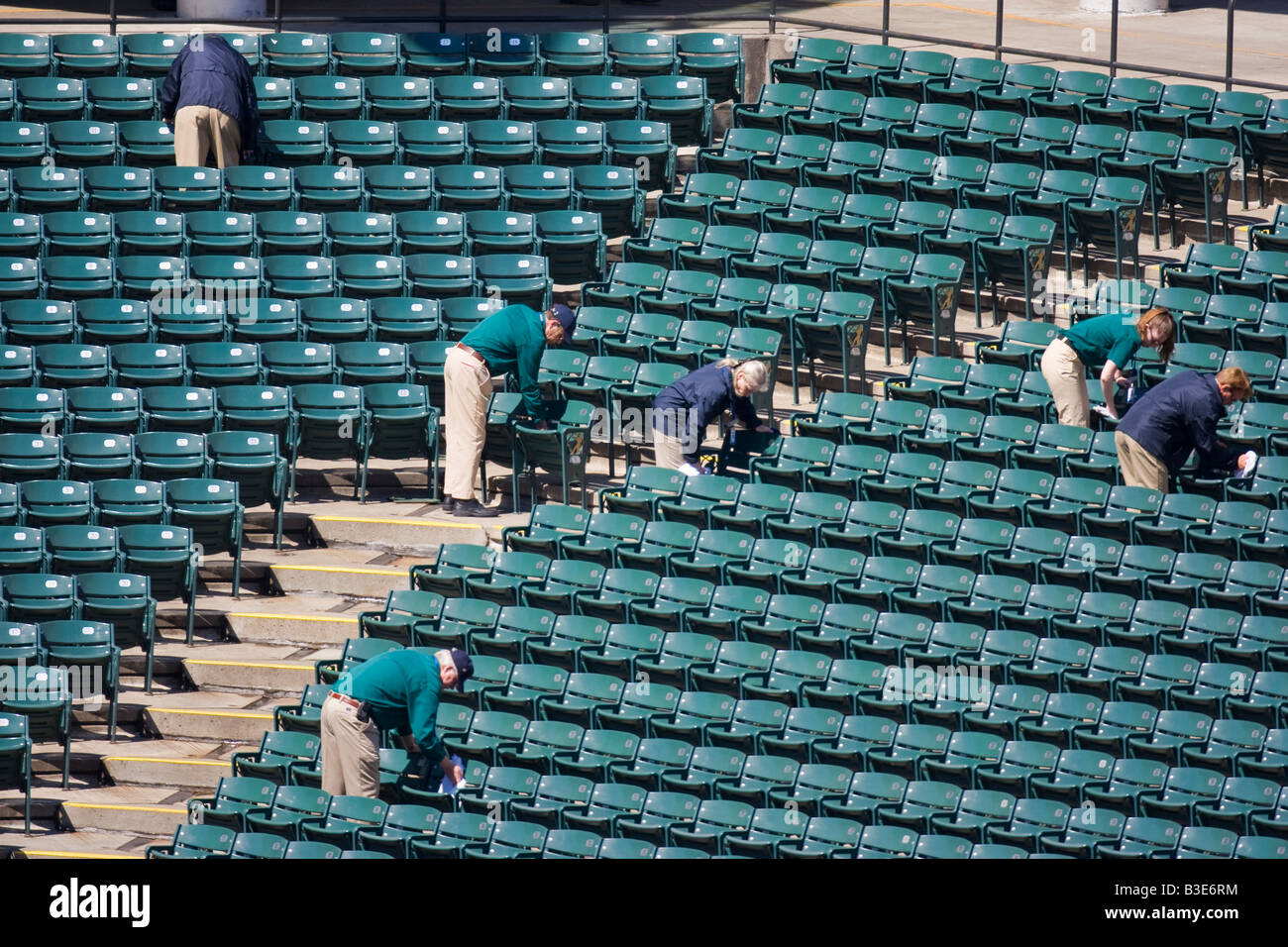 Workers cleaning stadium seats Stock Photo - Alamy