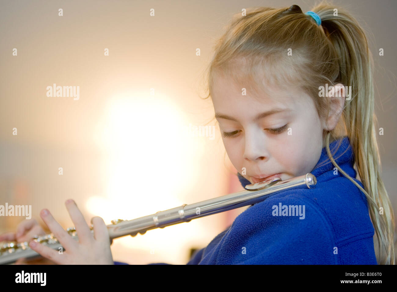 Young girl playing a flute Stock Photo - Alamy