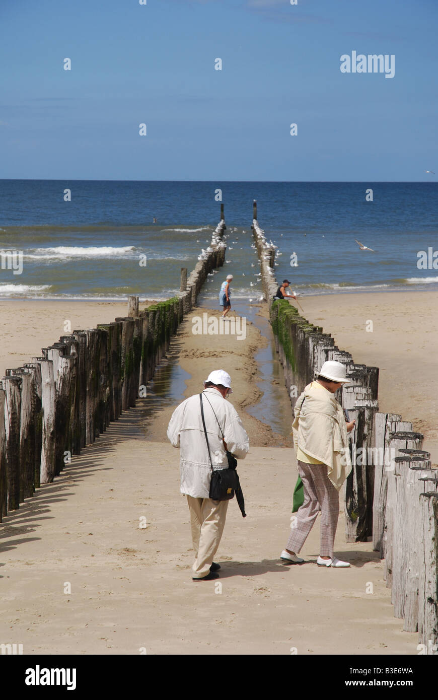 mature couple strolling on the beach Stock Photo - Alamy