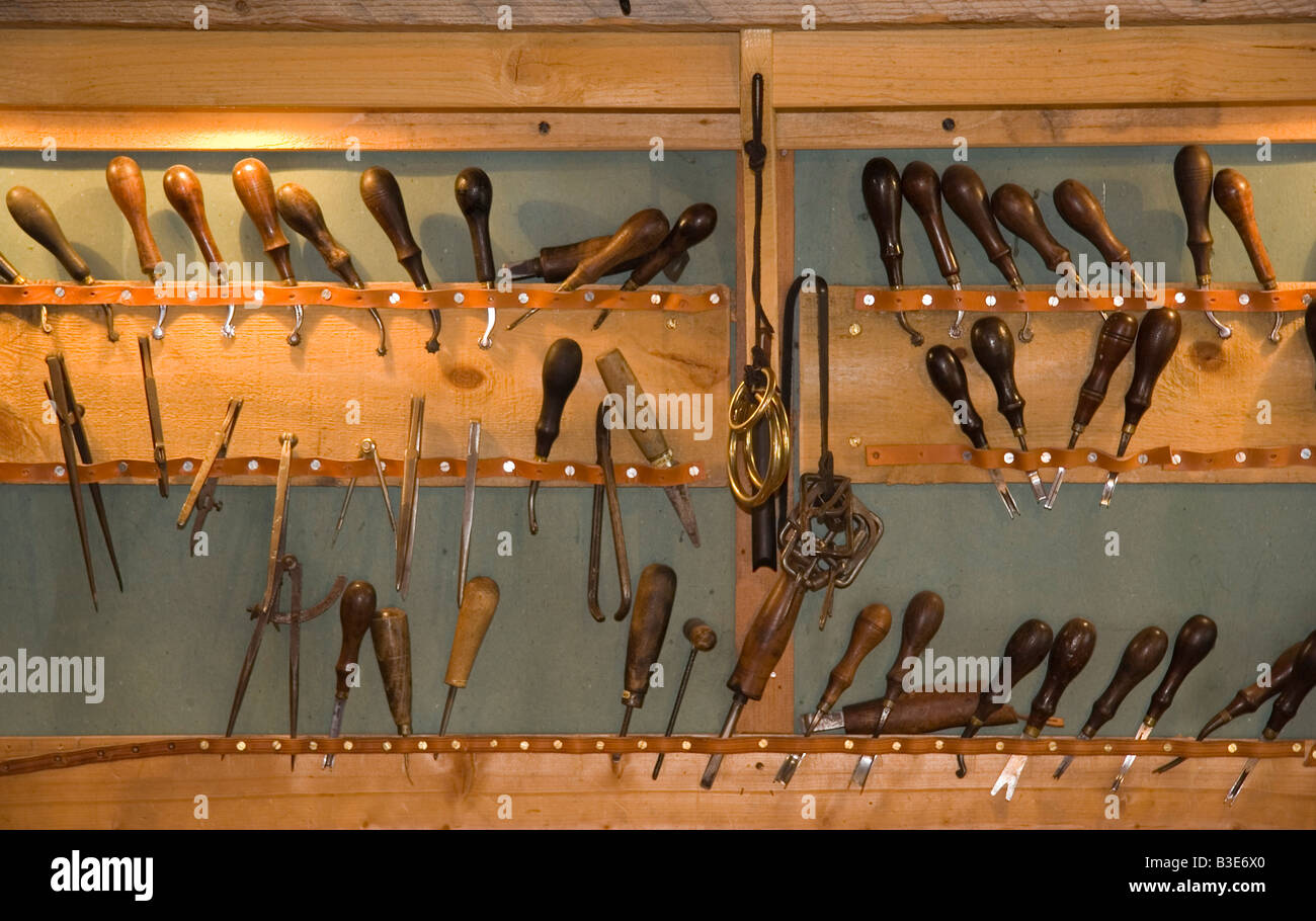 vintage leatherworking tools on a wall Stock Photo - Alamy