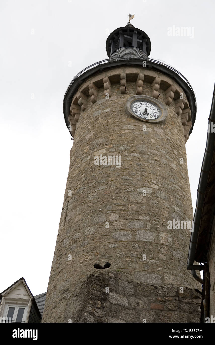 clock tower with two pigeons perched on a ledge in Meymac, France Stock ...