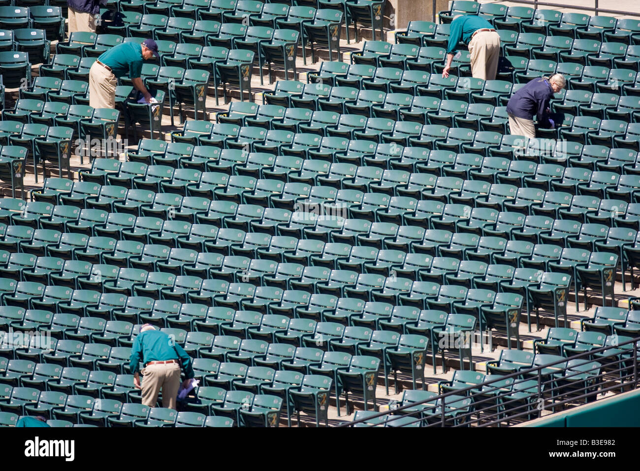 Workers cleaning stadium seats Stock Photo - Alamy