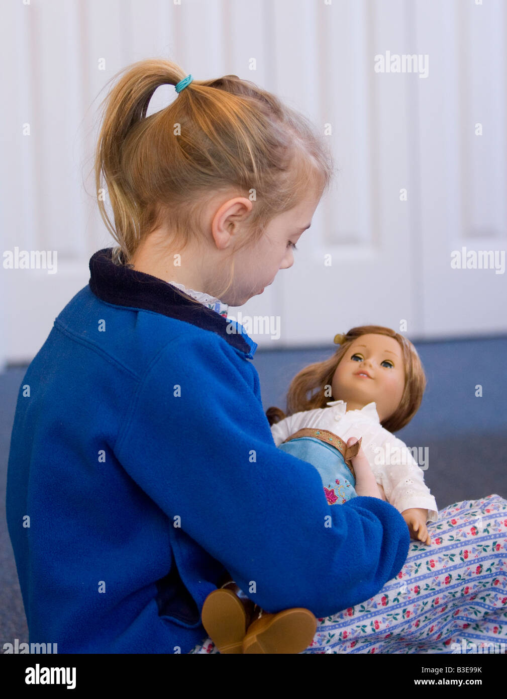 Year old girl playing doll hi-res stock photography and images - Alamy