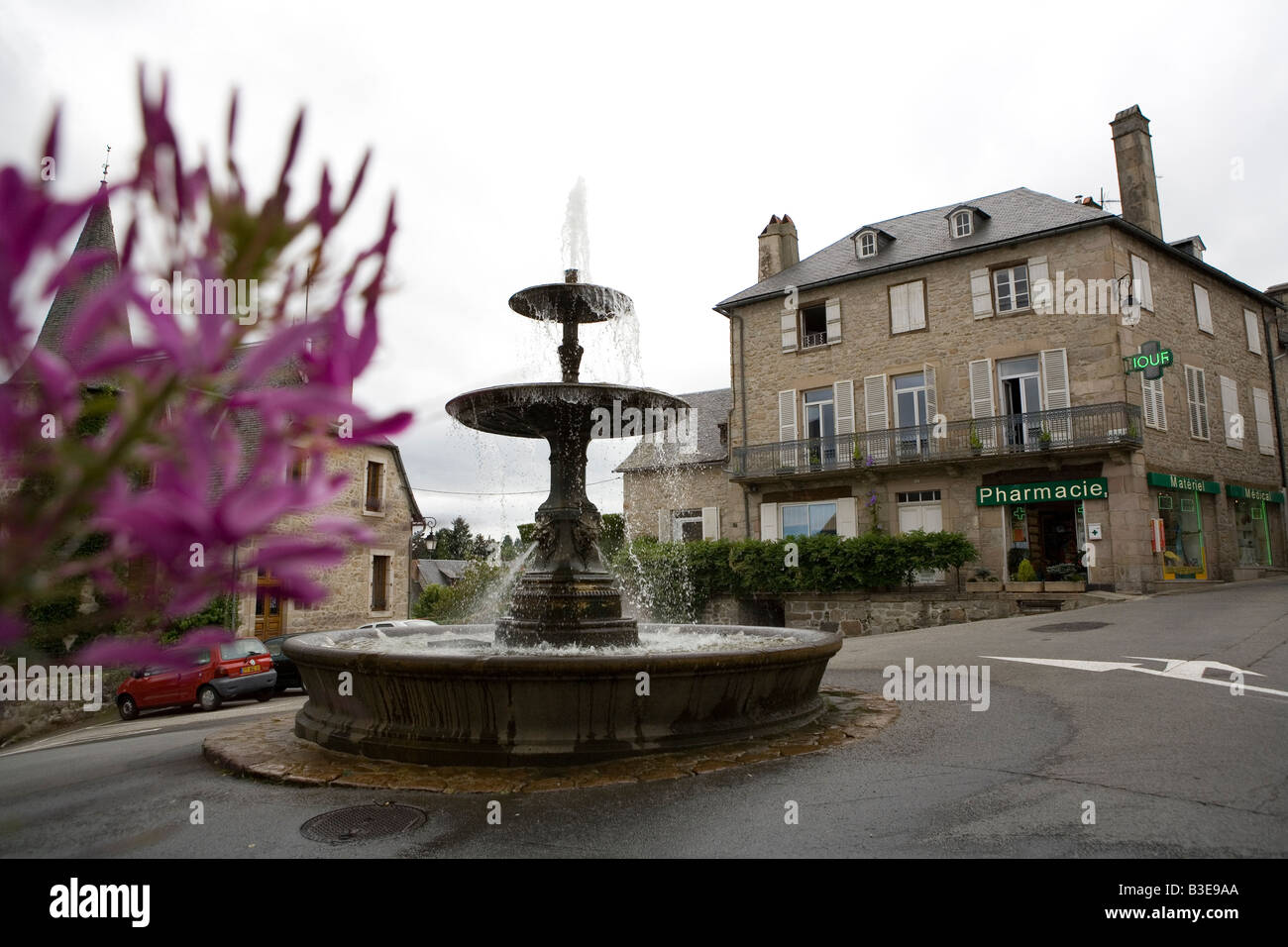 fountain and pharmacie in the centre of Meymac, France Stock Photo - Alamy