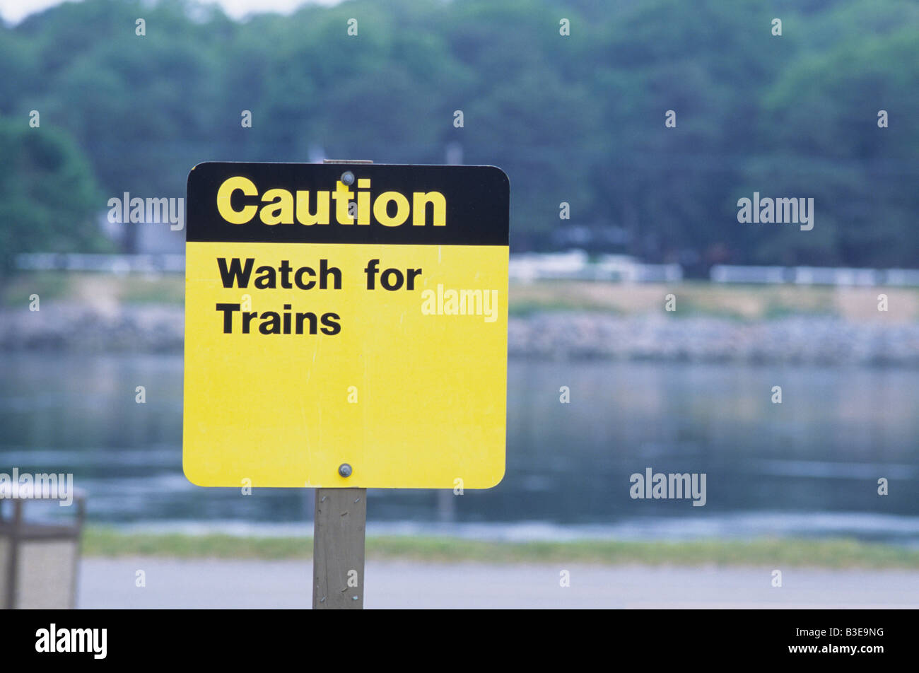 Yellow and black caution watch for train sign Stock Photo - Alamy