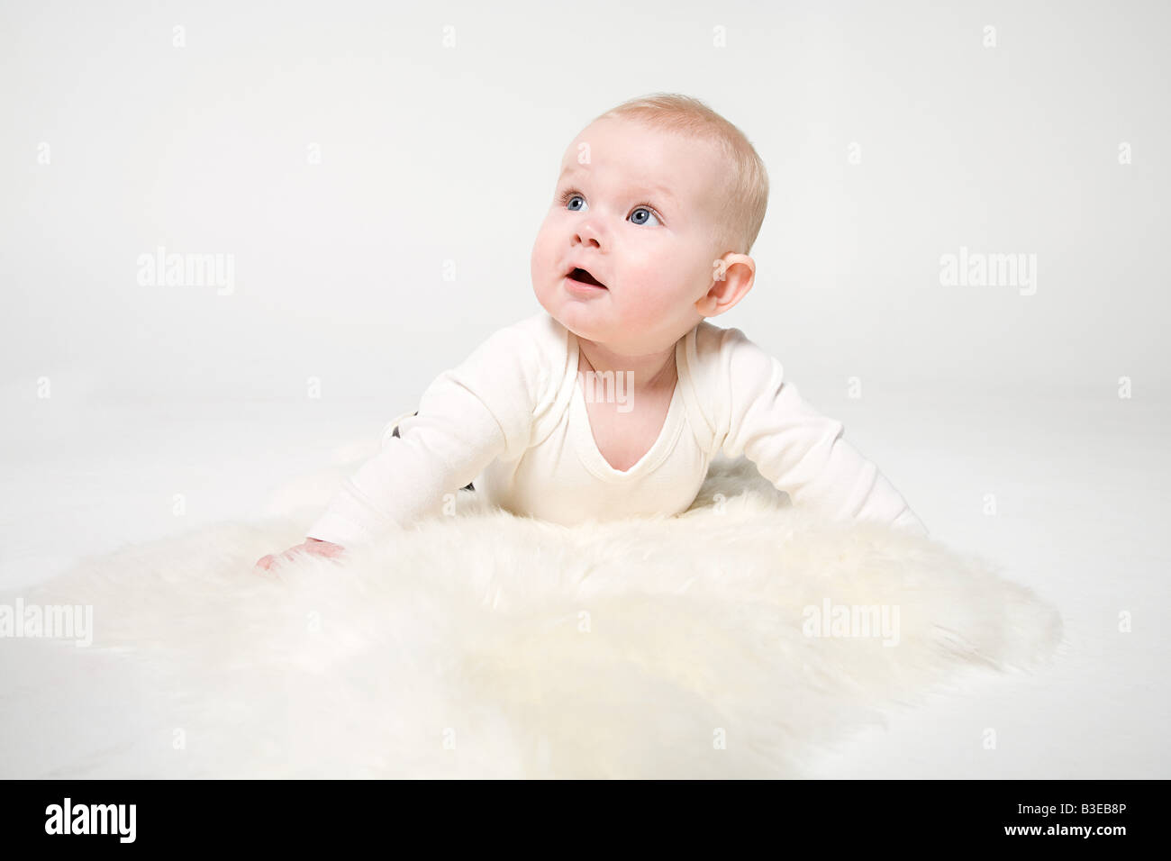 A baby girl lying on a rug Stock Photo - Alamy