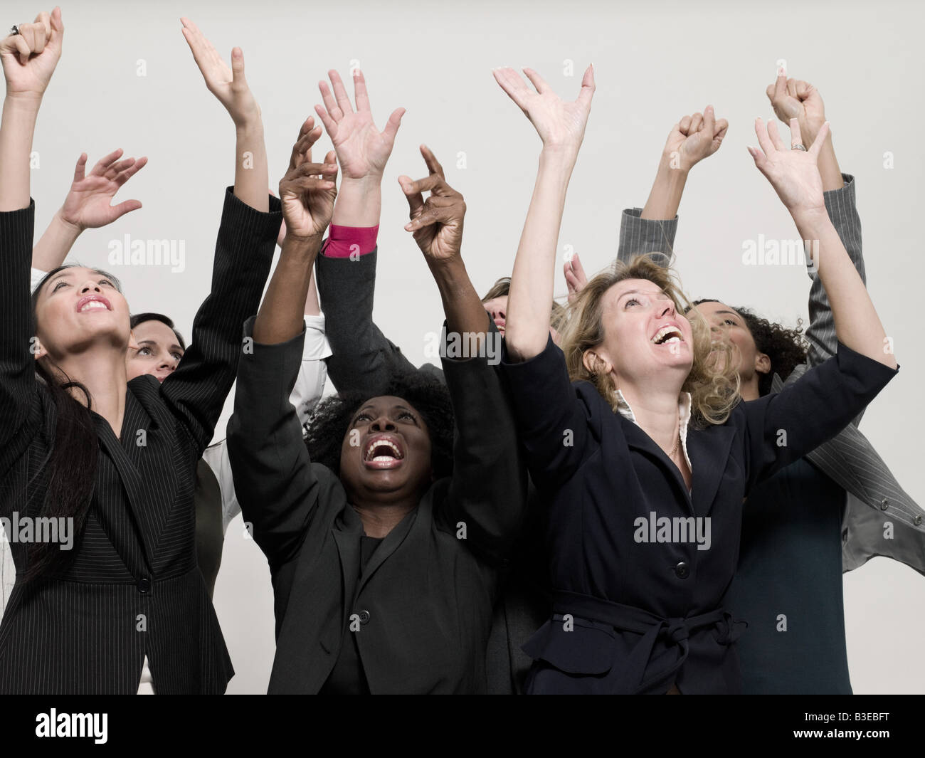 Businesswomen with arms raised Stock Photo - Alamy