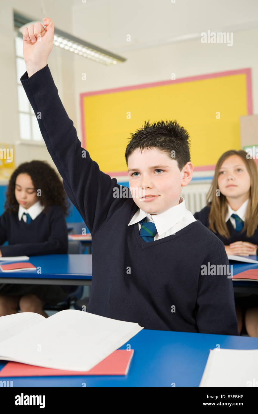 Boy with hand raised Stock Photo - Alamy