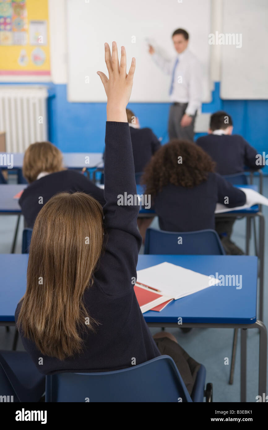 Girl with hand raised Stock Photo - Alamy