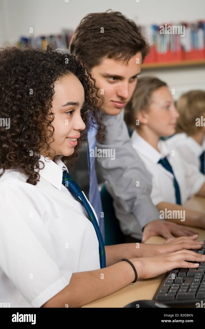 Teacher and girl with computer Stock Photo - Alamy