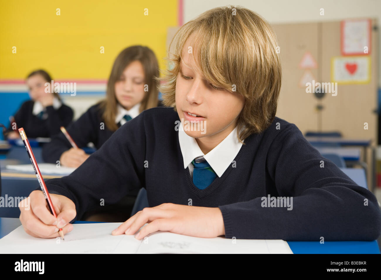 School students writing Stock Photo - Alamy