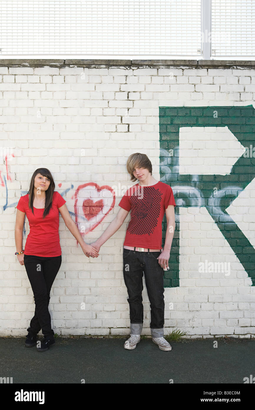 Teenage couple holding hands Stock Photo - Alamy