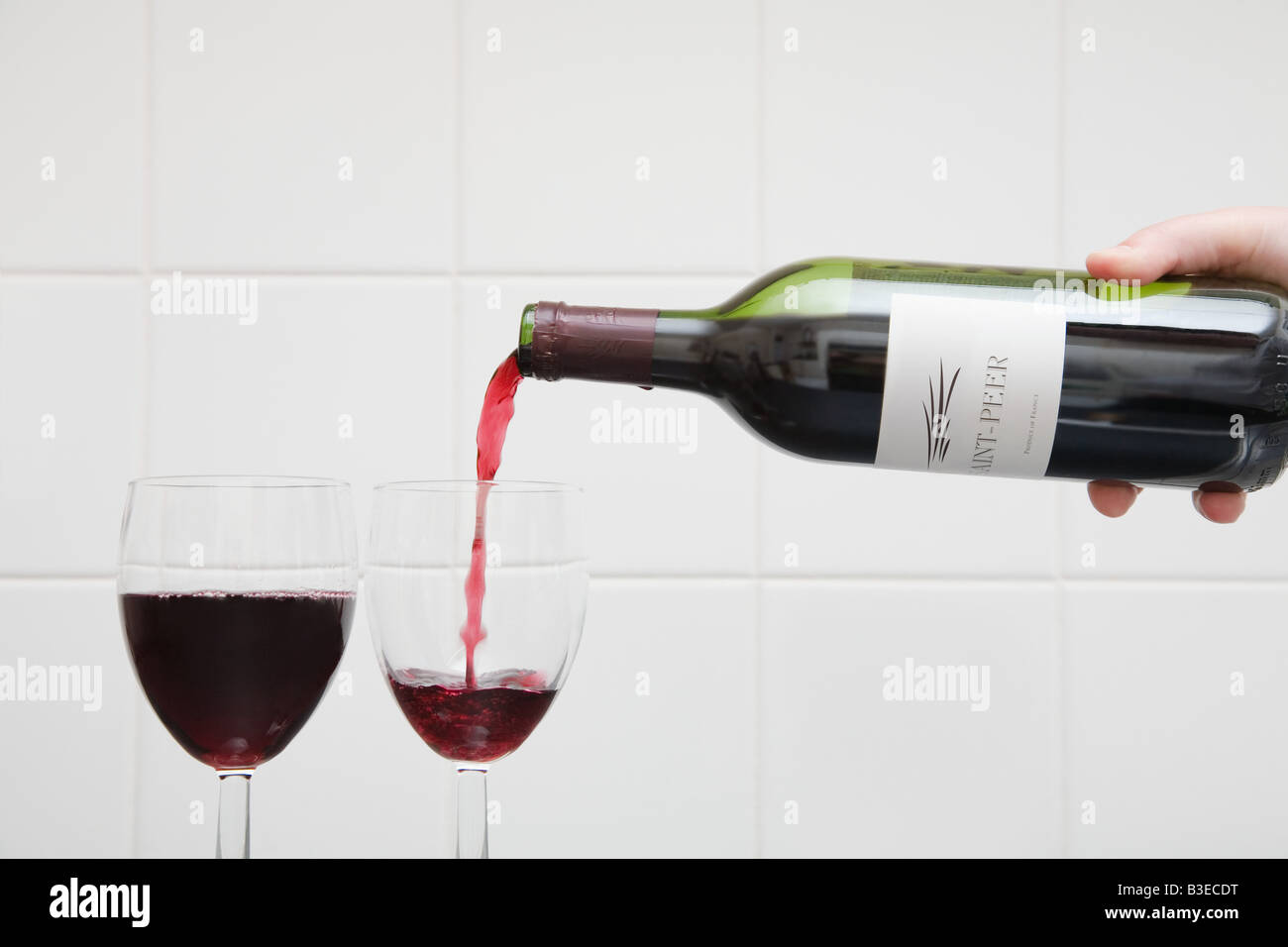 Pouring red wine Stock Photo - Alamy