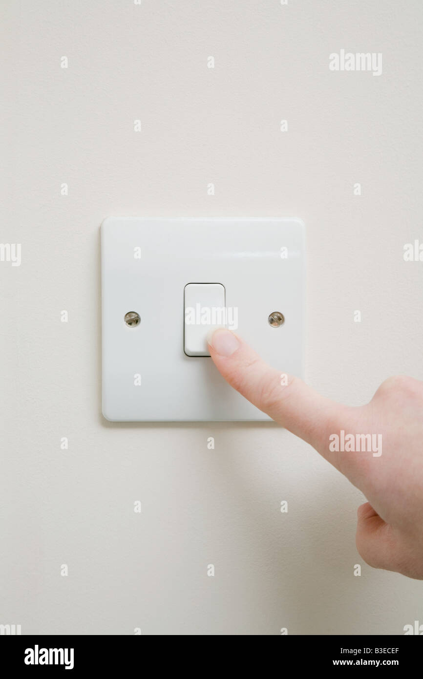 Person using light switch Stock Photo - Alamy