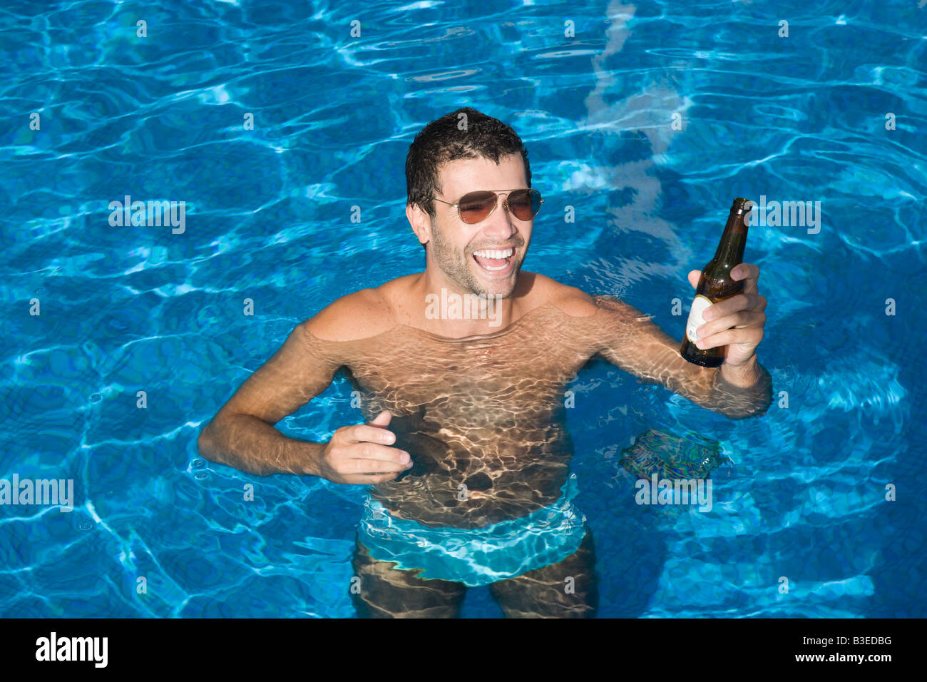 Man drinking beer in swimming pool Stock Photo - Alamy