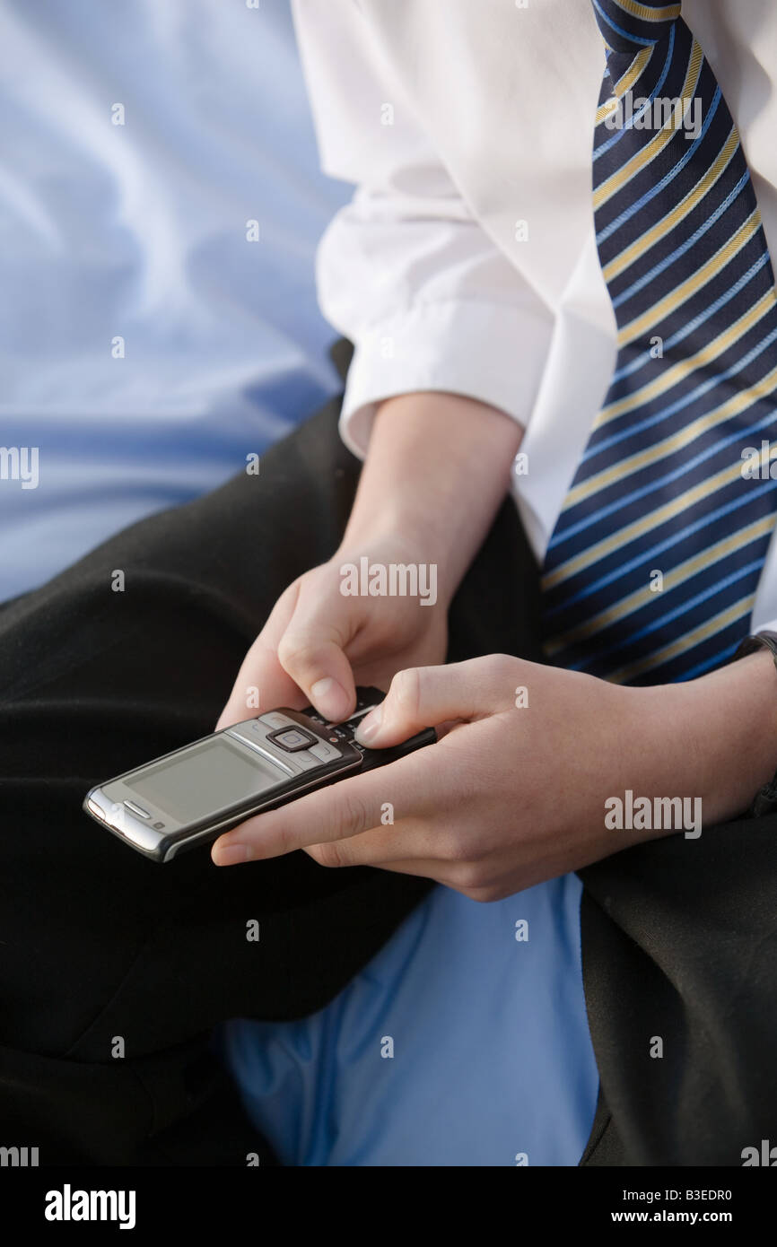 A teenage boy using a cell phone Stock Photo - Alamy