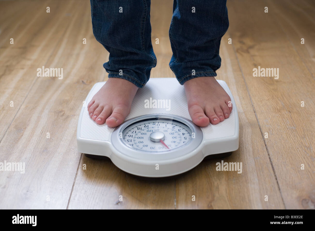 Person standing on scales Stock Photo - Alamy