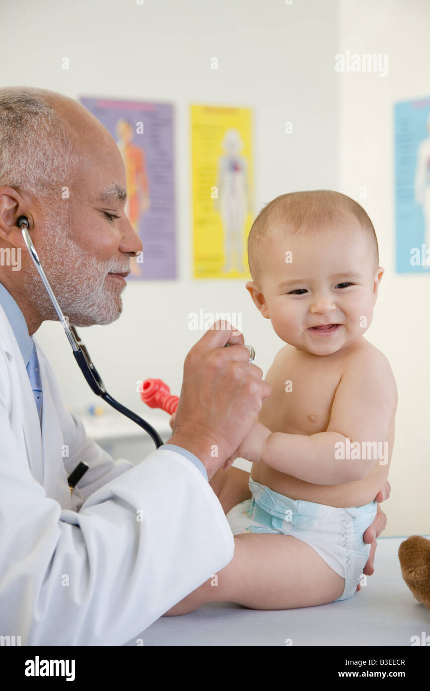 Doctor examining a baby Stock Photo - Alamy