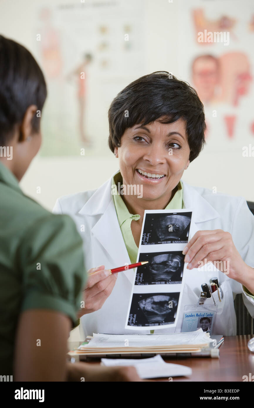 A doctor with a patient holding a scan Stock Photo - Alamy
