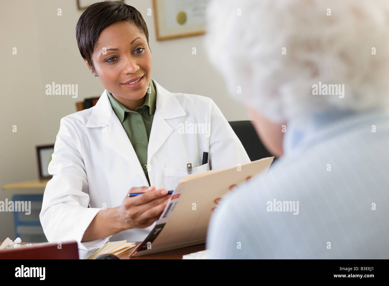 A doctor and a patient Stock Photo - Alamy