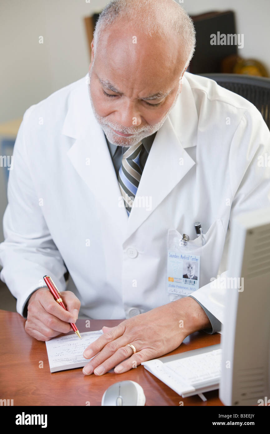 A doctor writing a prescription Stock Photo - Alamy