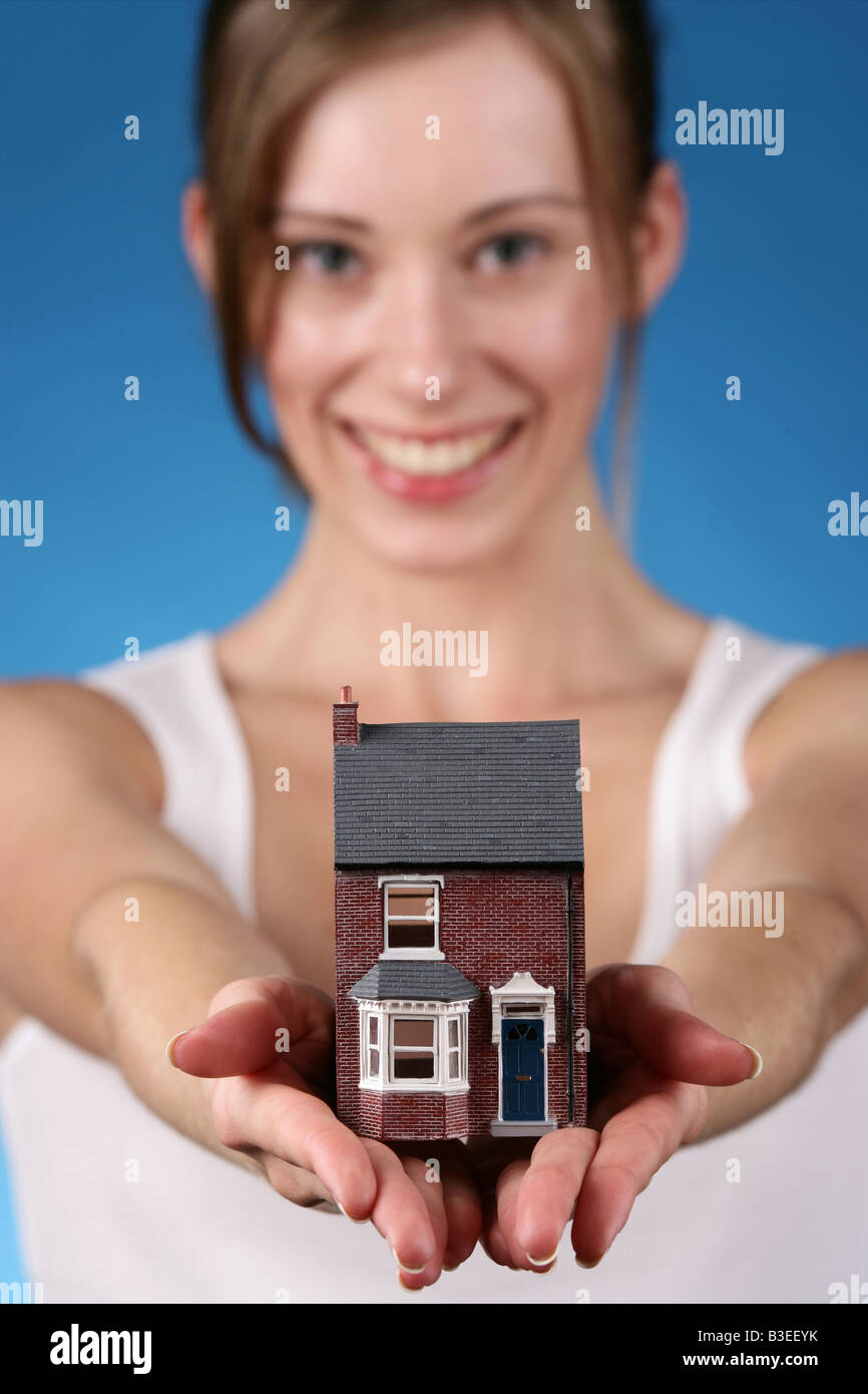 Female holding a model house Stock Photo - Alamy
