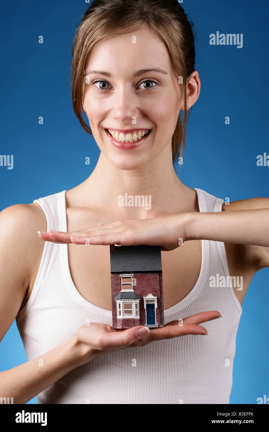 “Female holding a model house” Stock Photo - Alamy