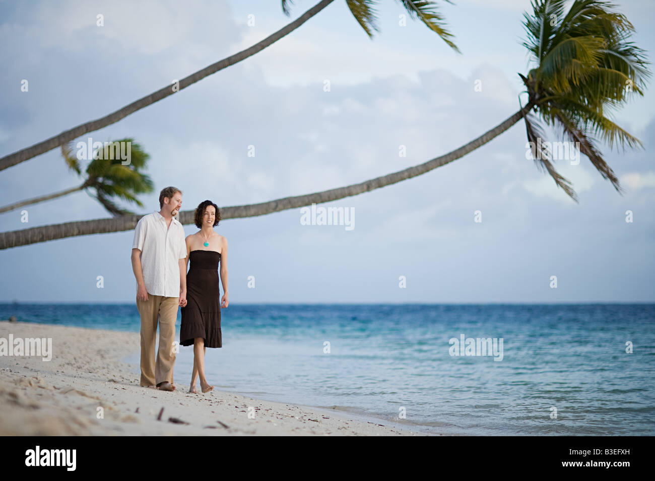 Couple on idyllic beach Stock Photo - Alamy